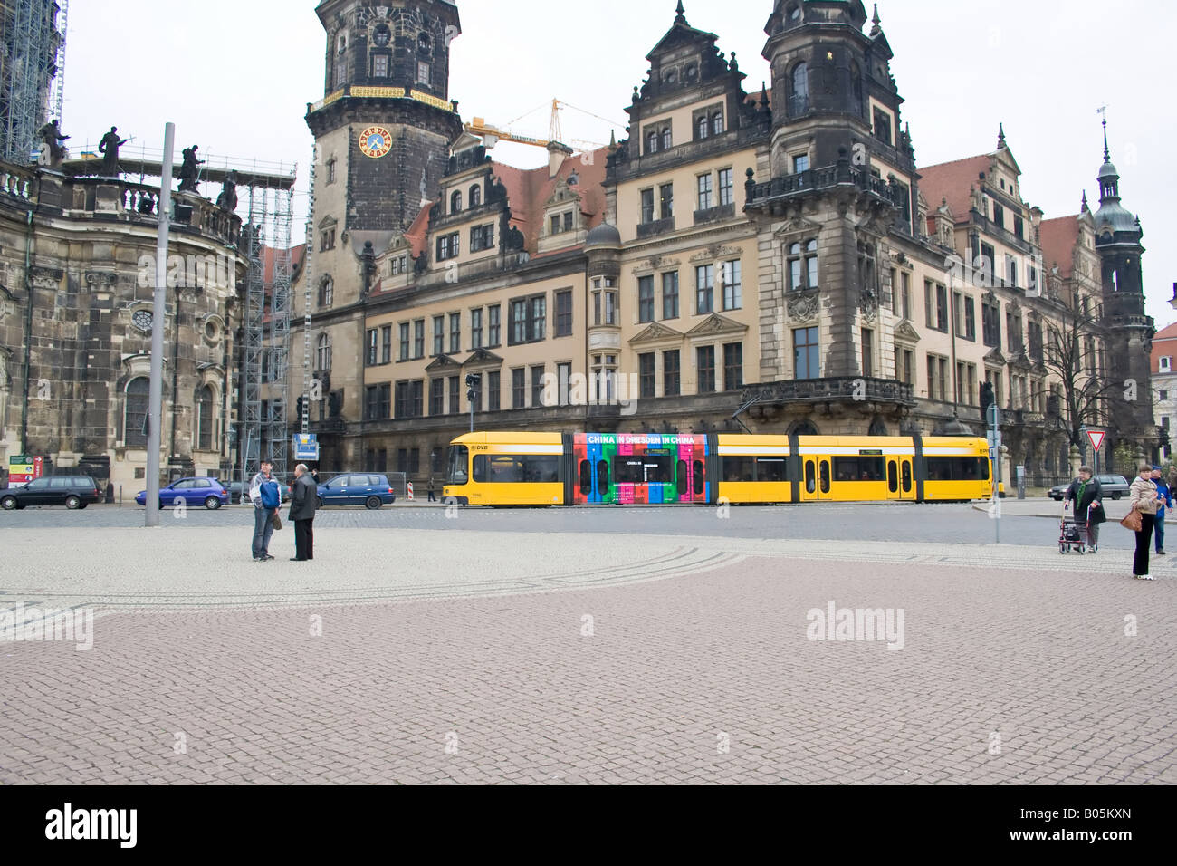 Tram passing by the historic architecture of Dresden, with people ...