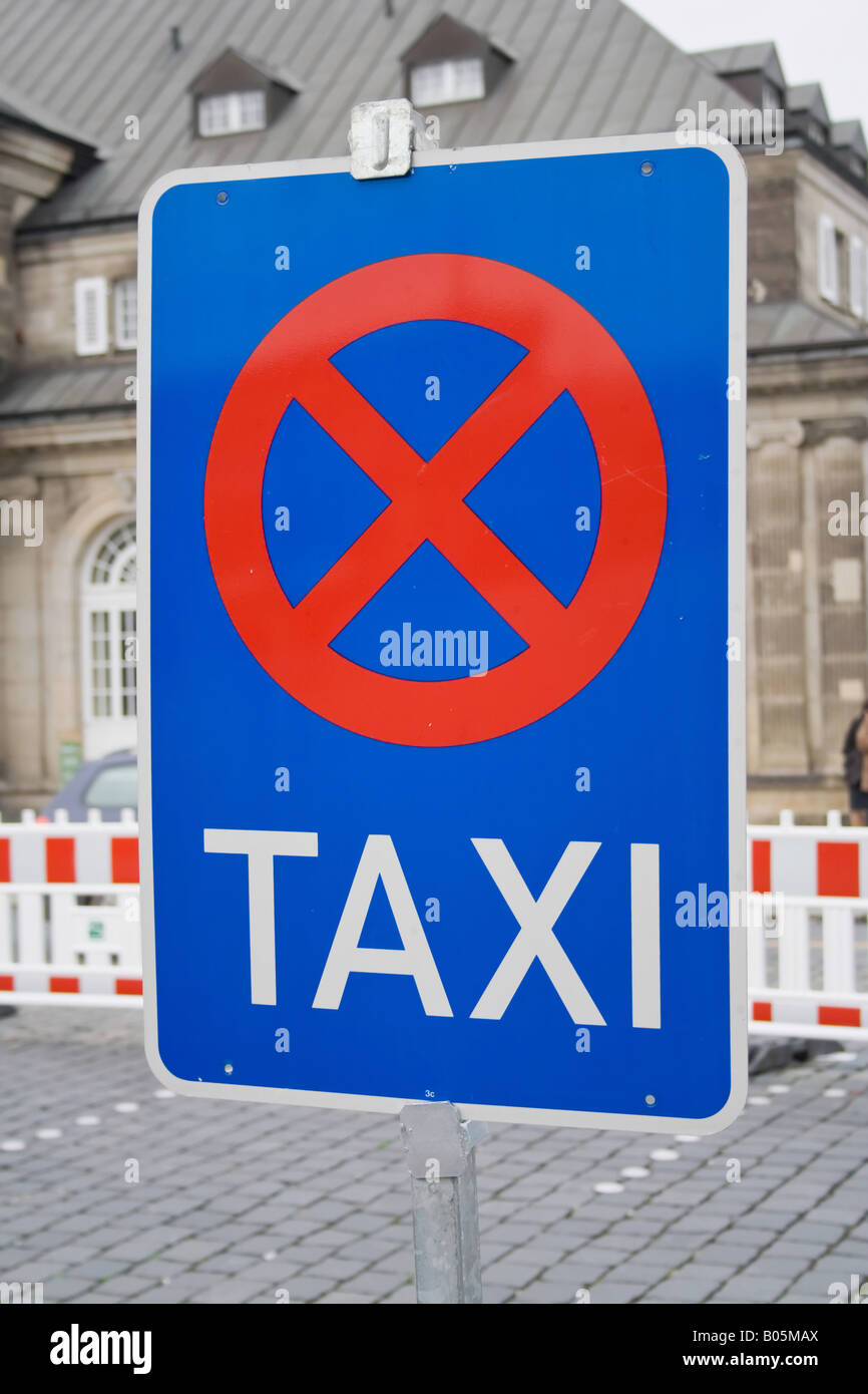 A blue road sign with a red crossed-out circle and the word "TAXI" in ...