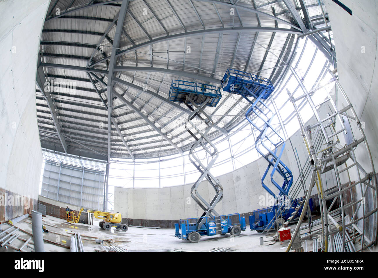 Scaffolding and two scissor lift platforms extended for working on a ...