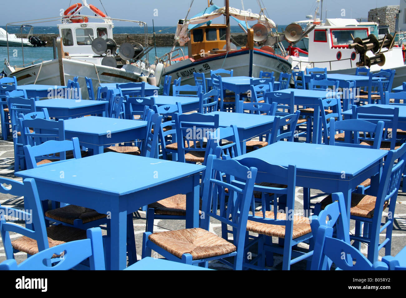 Blue Chairs at Greek Restaurant at waters edge, Naoussa Harbour, Paros ...