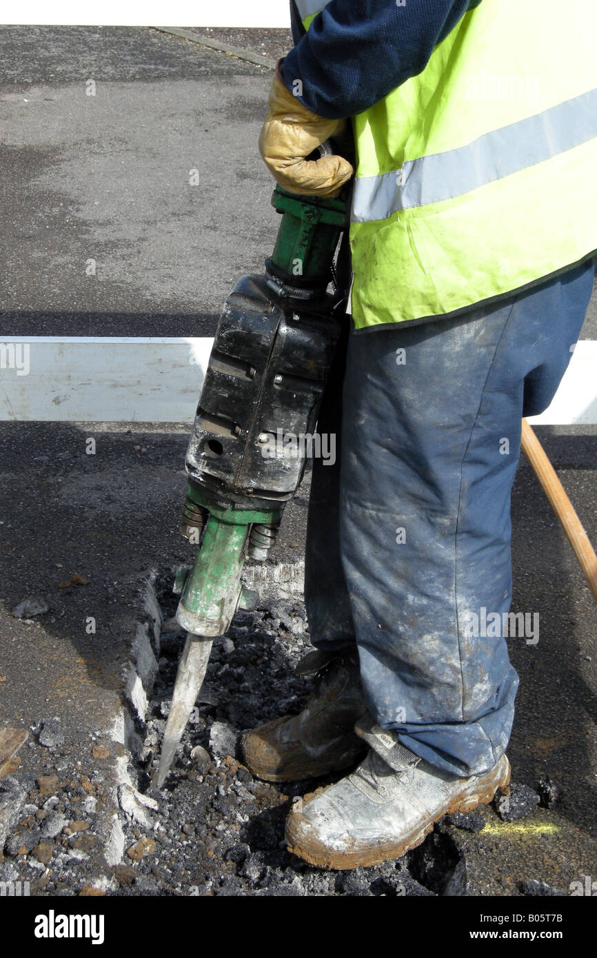 Professional workers using pneumatic hi-res stock photography and ...