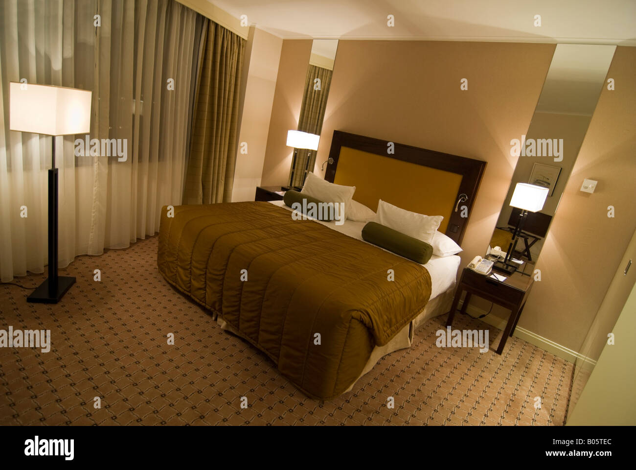 Horizontal wide angle interior view of a luxurious hotel bedroom ready ...