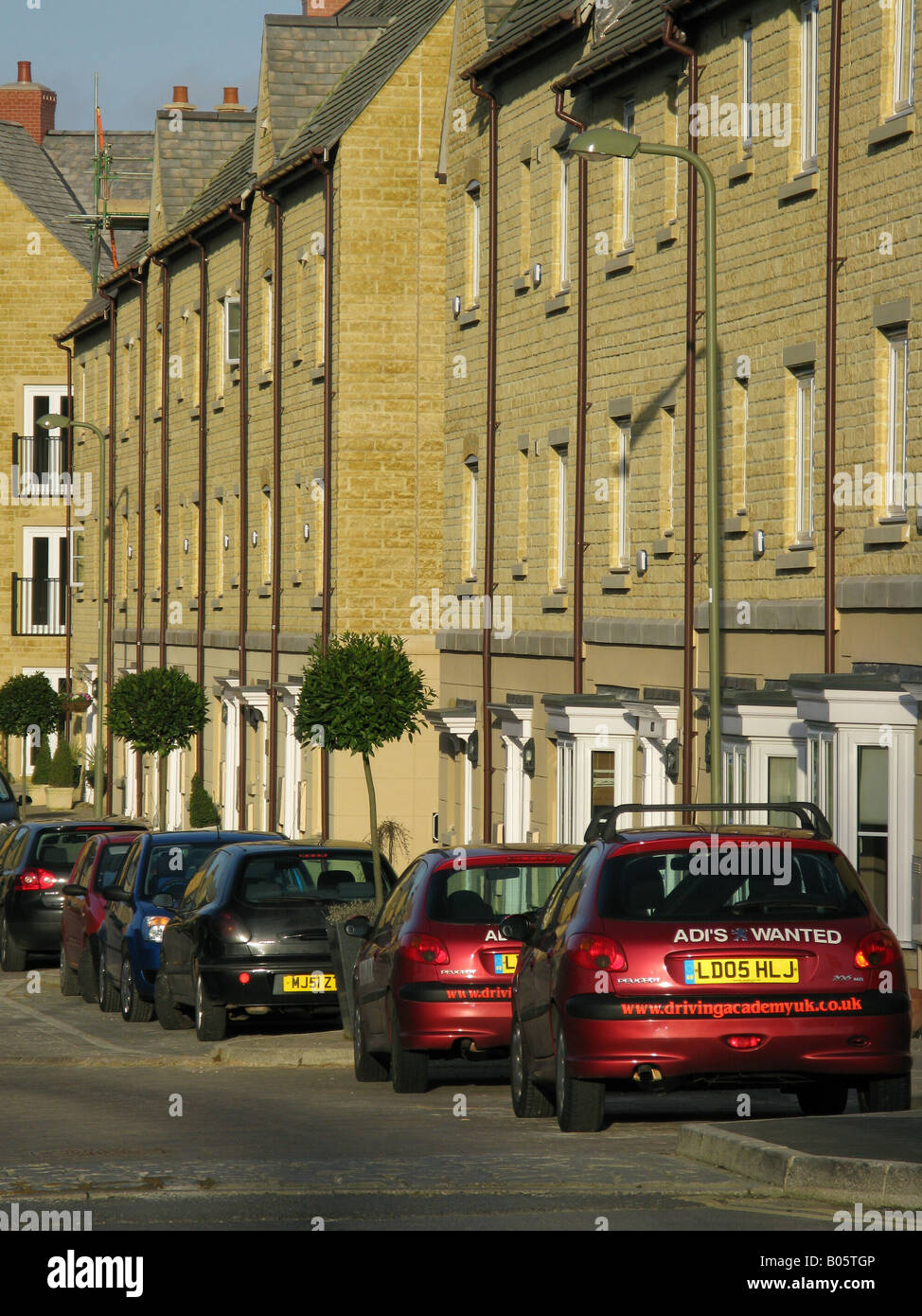 cars outside houses on new build development Stock Photo - Alamy