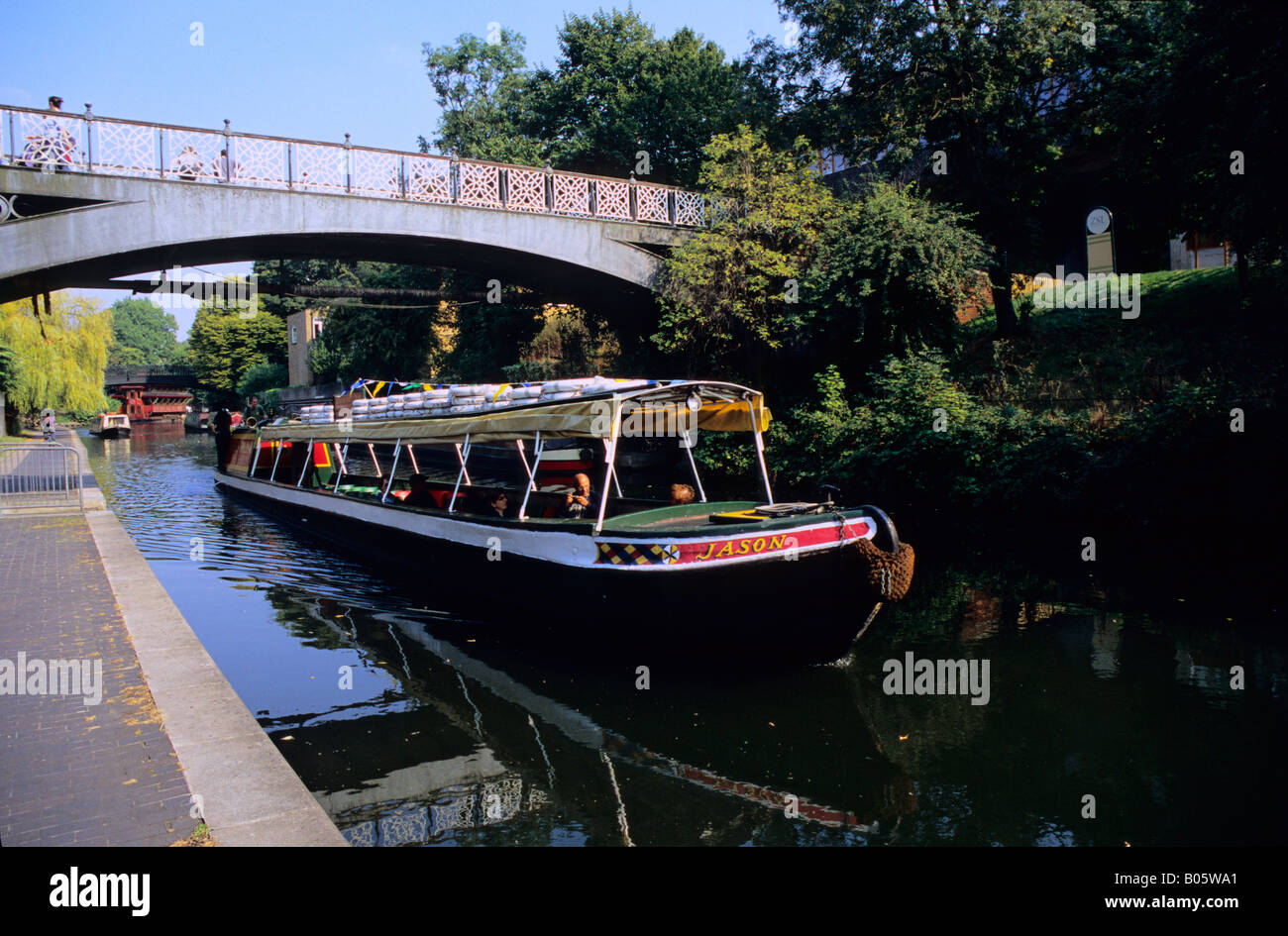 Canal passenger boat passing under bridge on the Regent's Canal, City ...