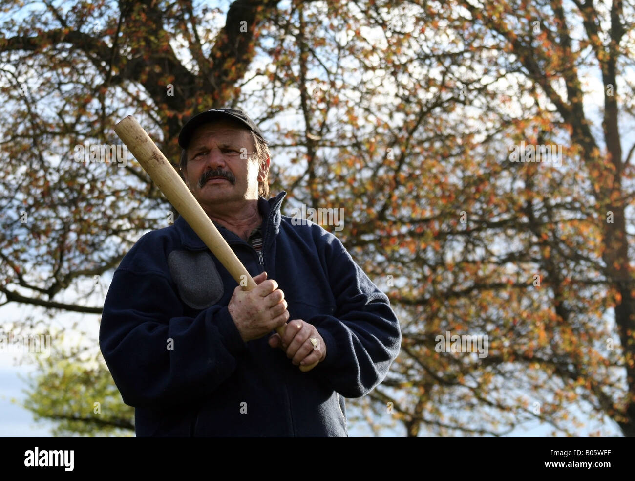 Older man practicing baseball with baseball bat in hands Stock Photo ...