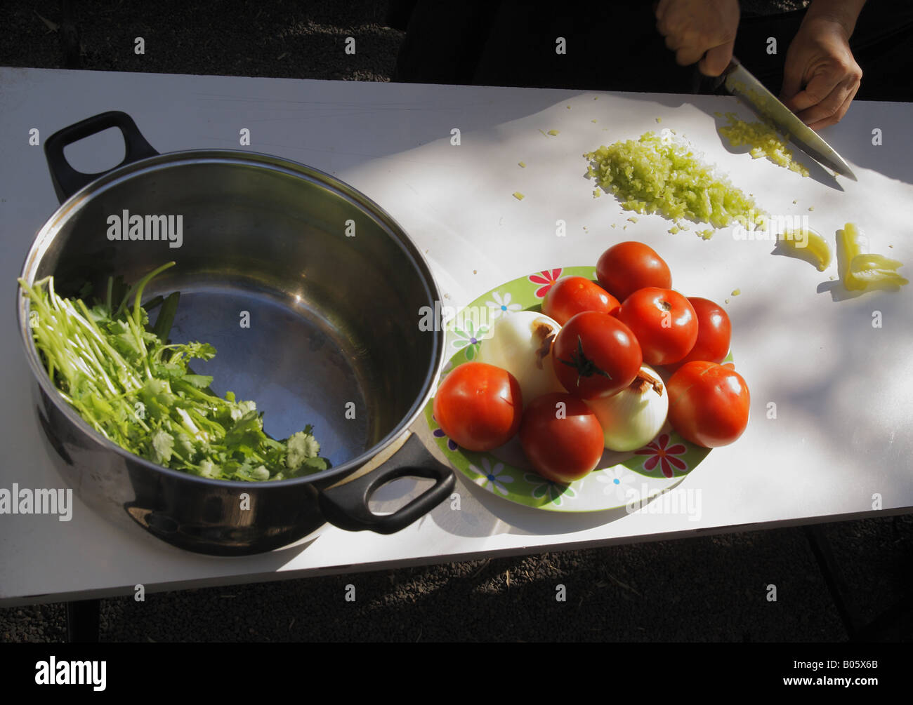 Preparation of pebre, a traditional Chilean sauce made with tomatoes ...