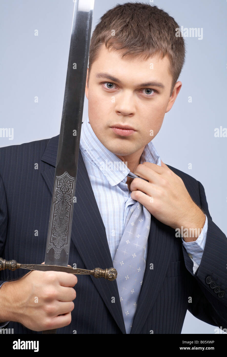 Young man holding samurai sword hi-res stock photography and images - Alamy