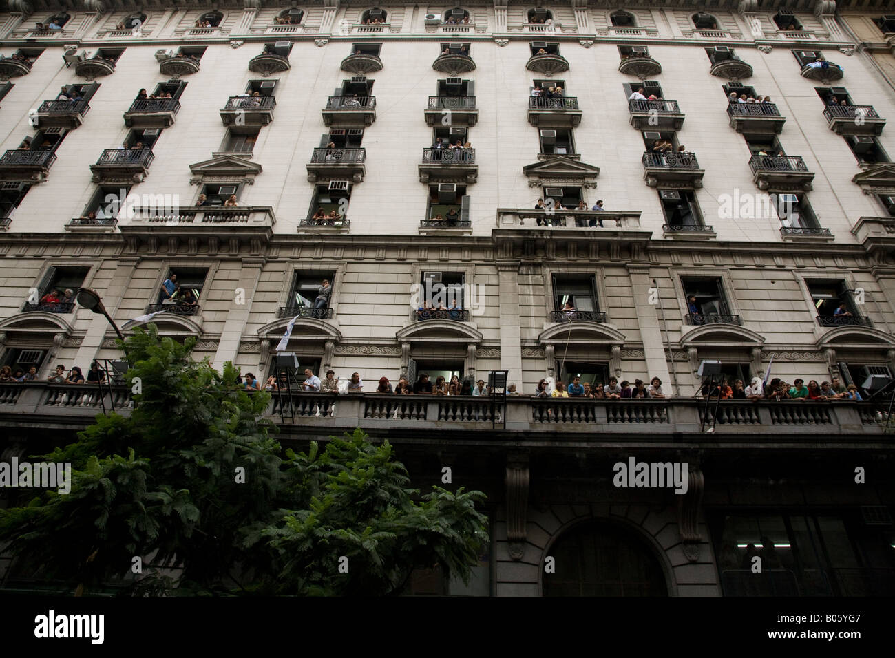 People hanging out the windows of a building on Diagonal Norte in ...