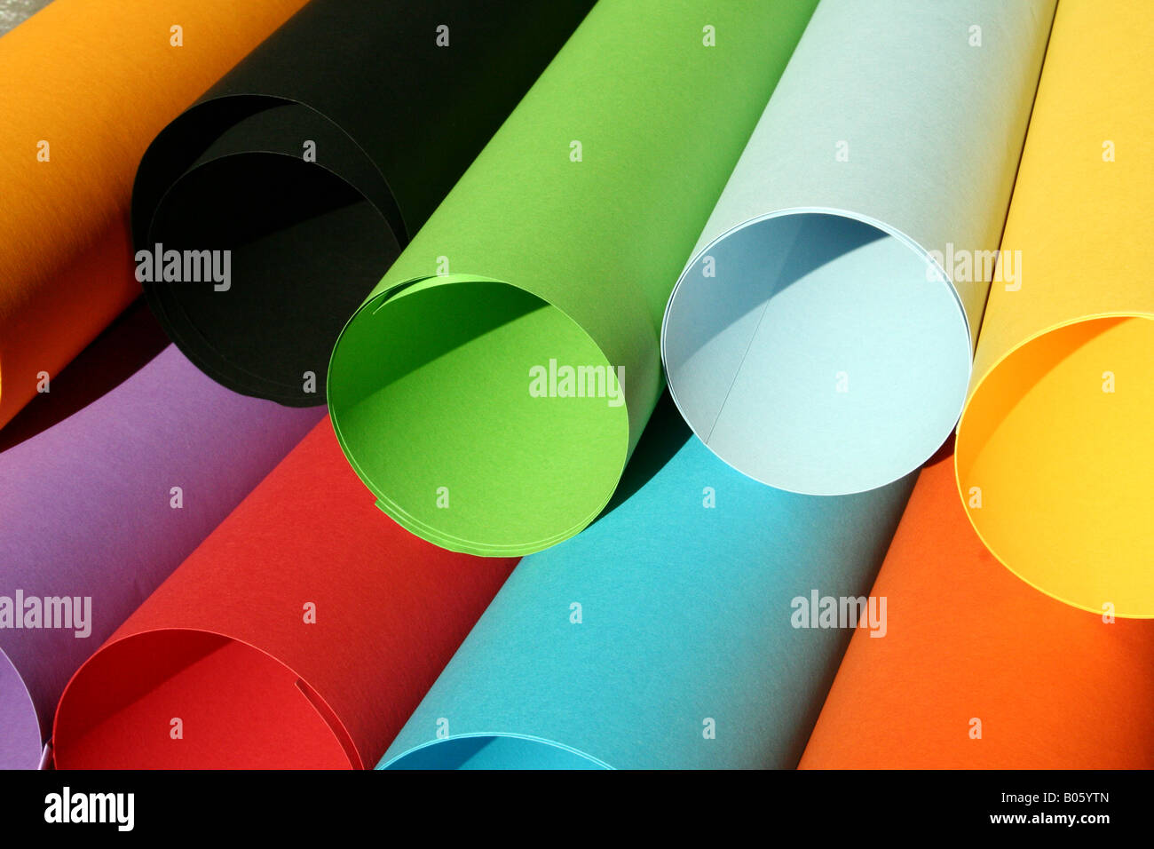 Rolls of colourful paper stacked together Stock Photo - Alamy