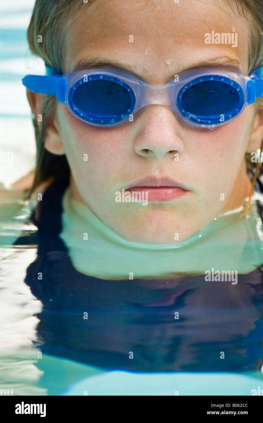 Young Caucasian girl wearing blue swim goggles in a pool Stock Photo ...
