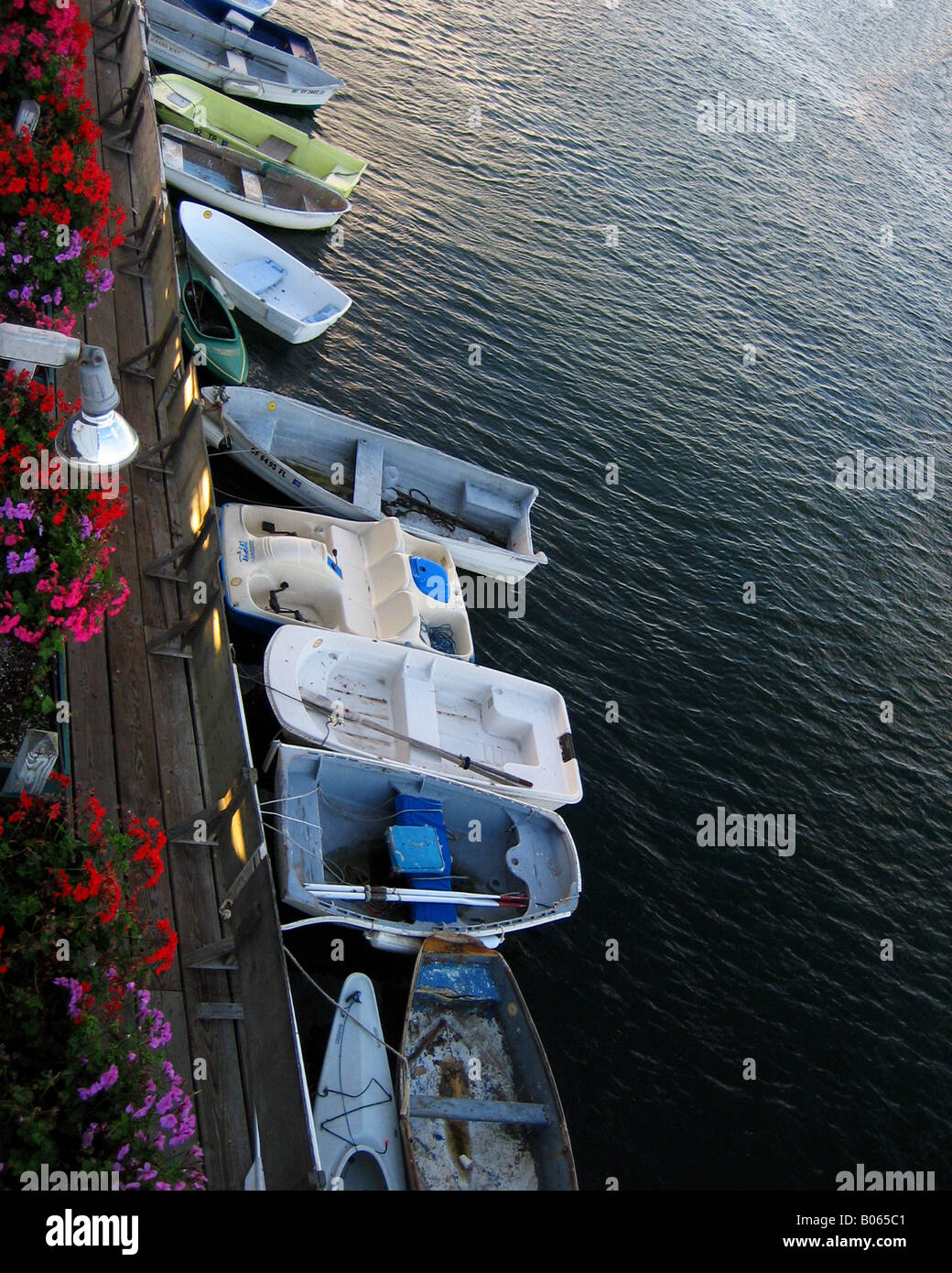 Color photo of boats in water next to a dock Stock Photo - Alamy