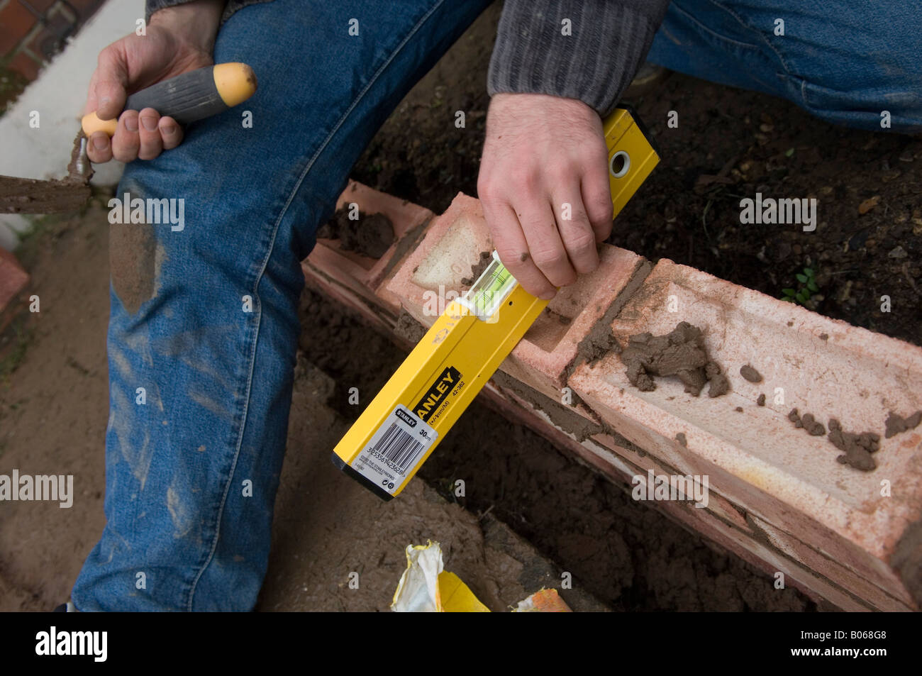 DIY How to build a brick wall Stock Photo - Alamy