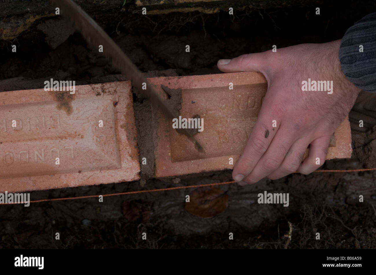 DIY How to build a brick wall Stock Photo - Alamy