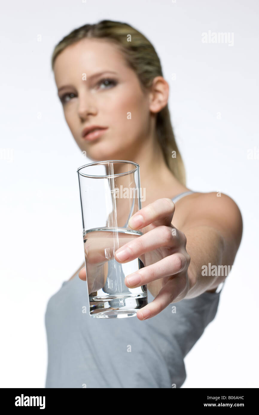 young woman offering a glass of water Stock Photo - Alamy