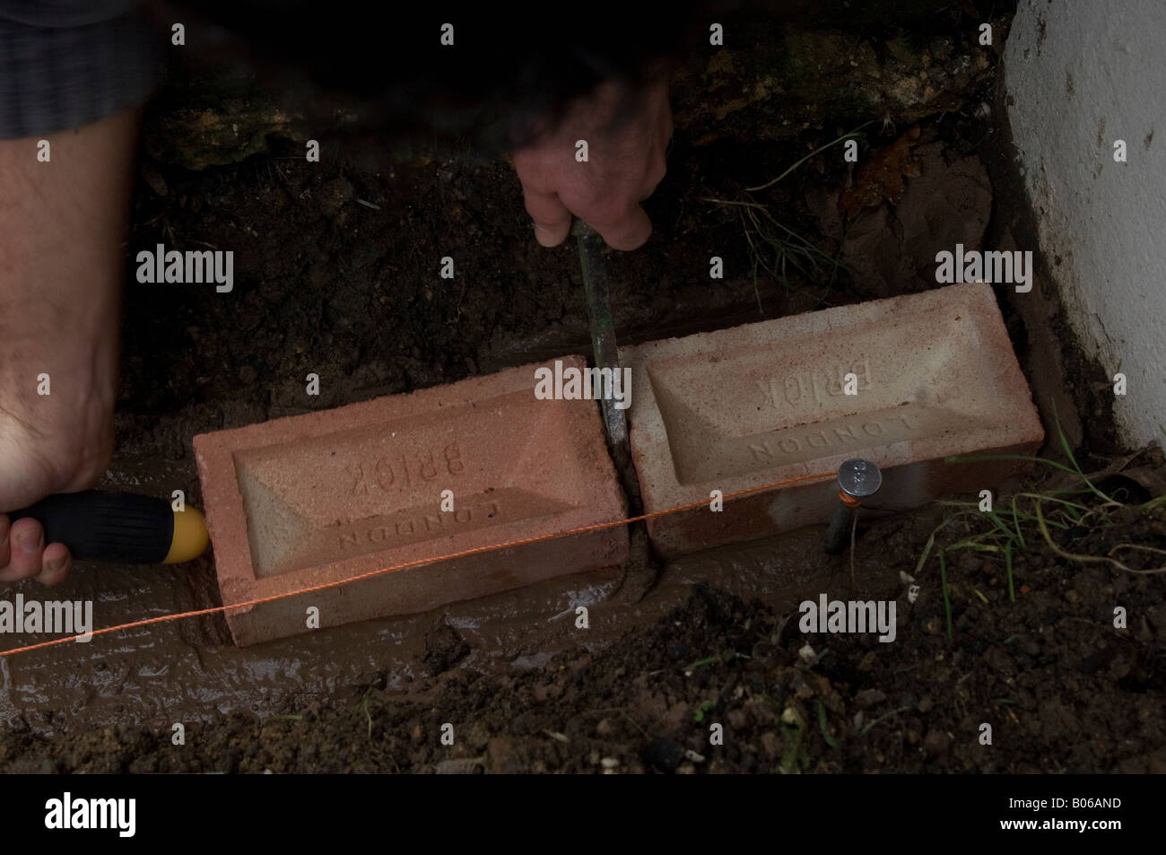 DIY How to build a brick wall Stock Photo - Alamy