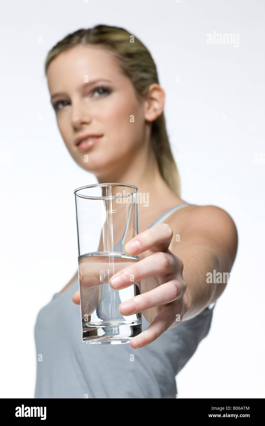 young woman offering a glass of water Stock Photo - Alamy