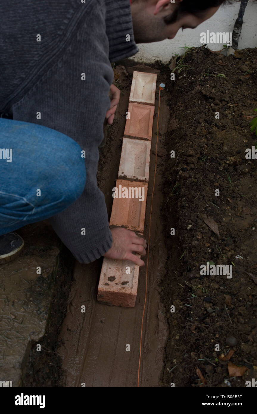 DIY How to build a brick wall Stock Photo - Alamy