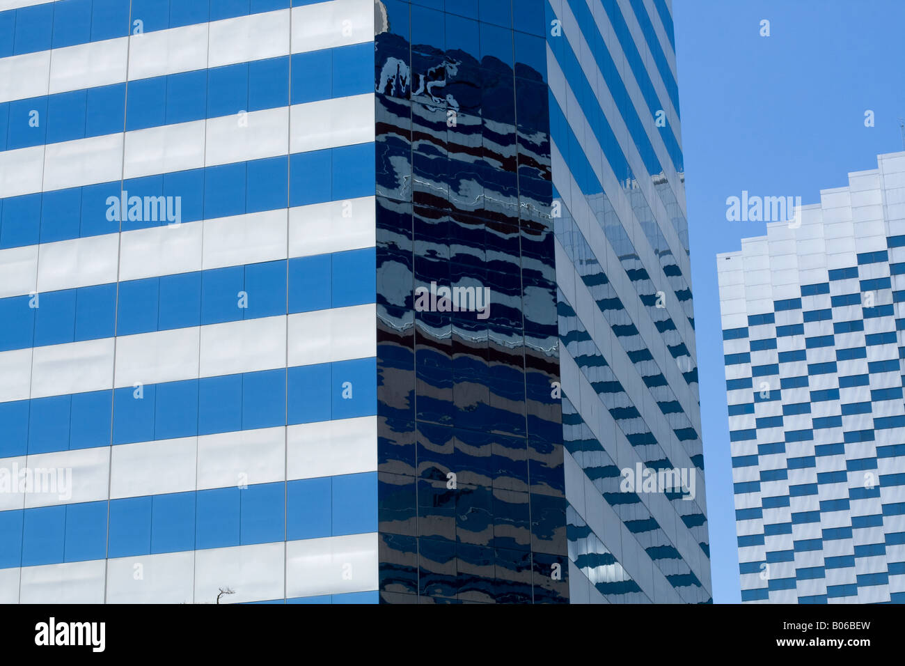 Tall building with mirror windows with another building in the ...