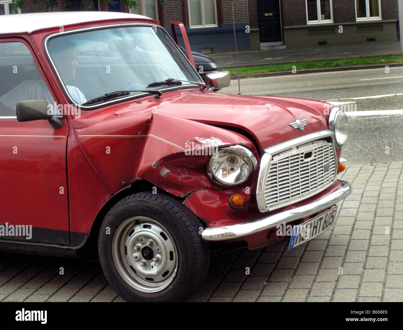 three quarter view of accident damaged red Mini Stock Photo - Alamy