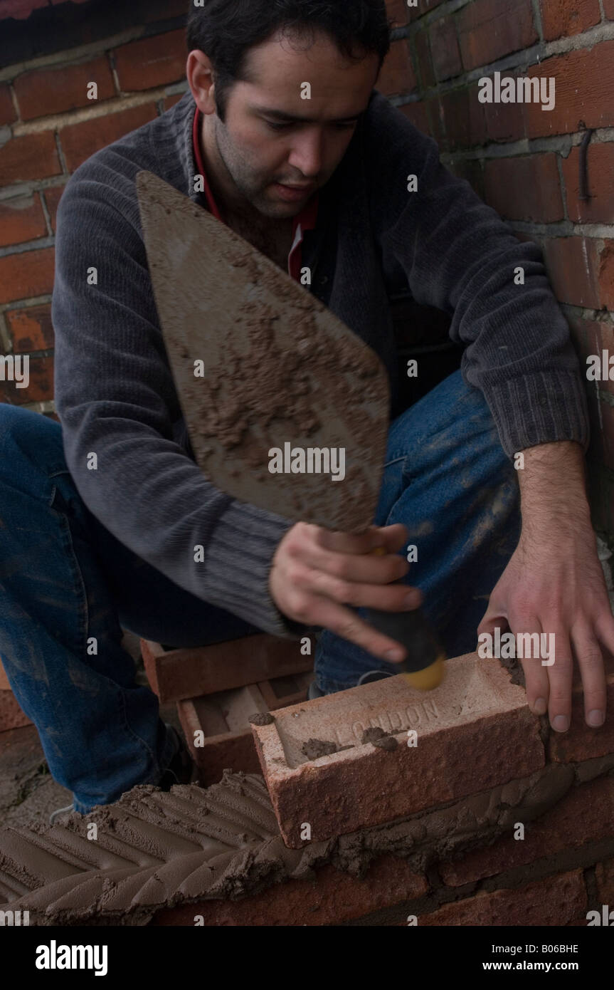 DIY How to build a brick wall Stock Photo - Alamy