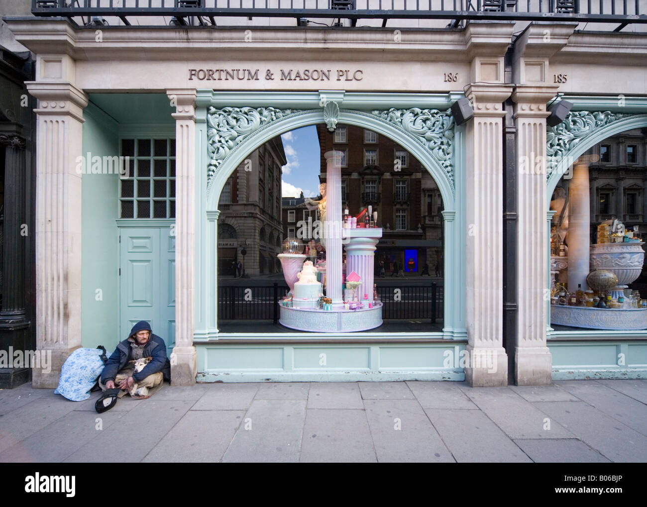 A homeless man begs outside Fortnum and Masons department store ...