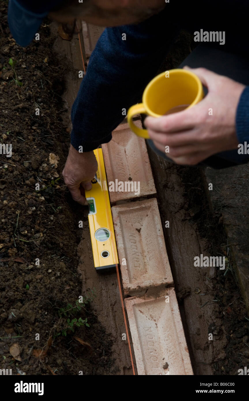 DIY How to build a brick wall Stock Photo - Alamy