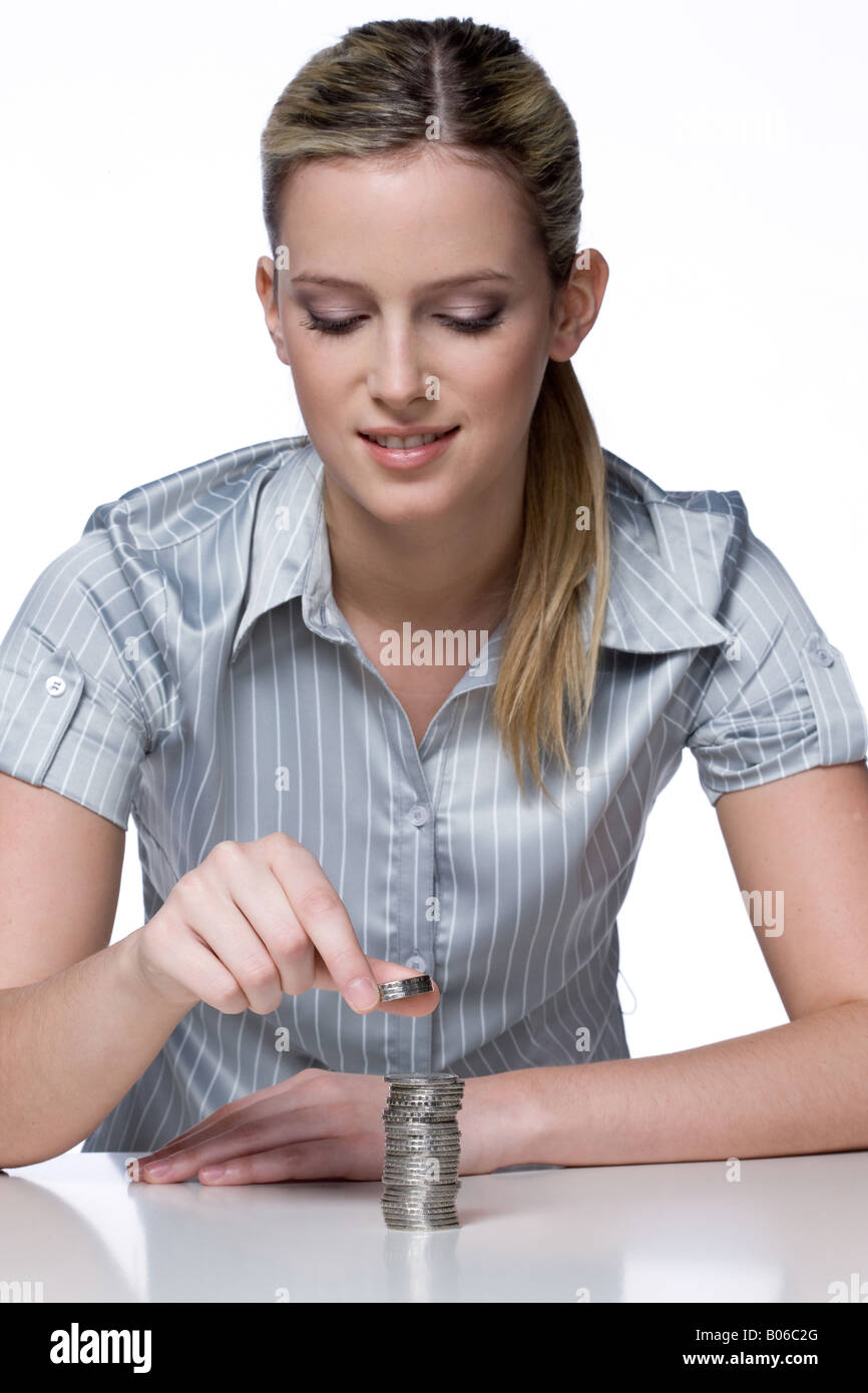 Woman with coins Stock Photo - Alamy