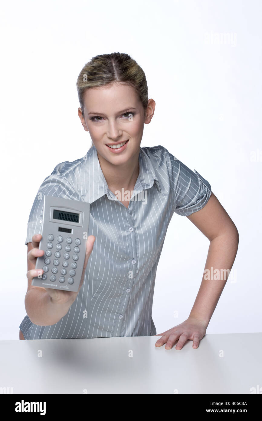 Woman with calculator Stock Photo - Alamy