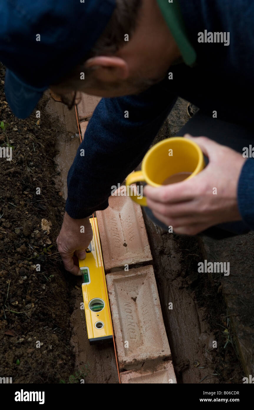 DIY How to build a brick wall Stock Photo - Alamy