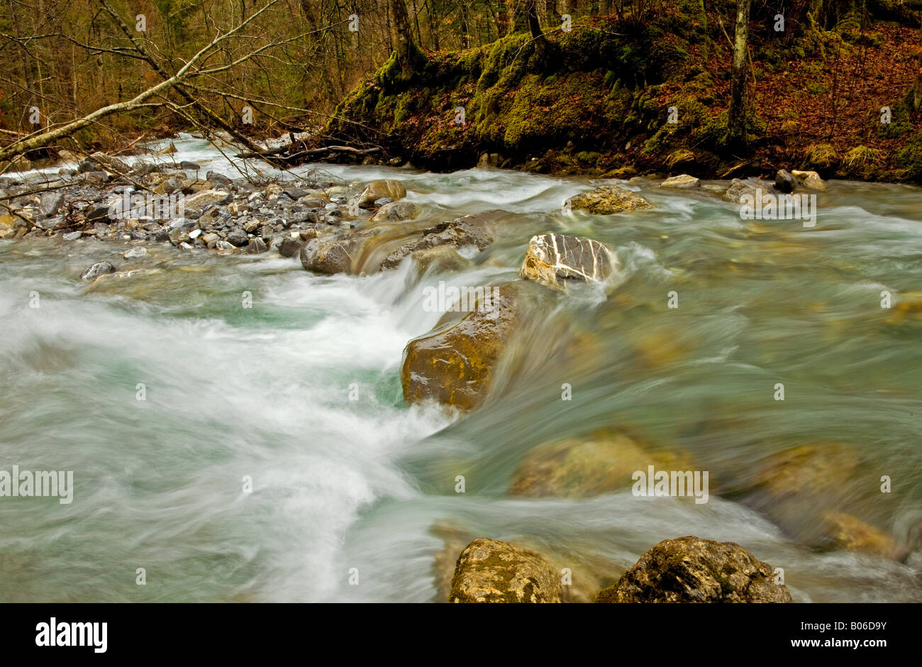 Snow melt water rushes over rocks on the River Dranse in the French ...