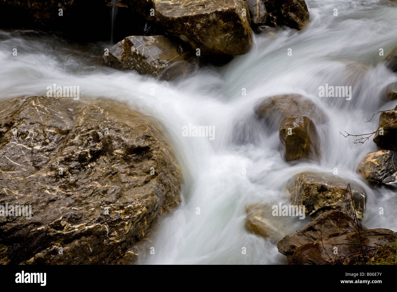 Swirling Dranse River water makes its way over granite and rocks ...