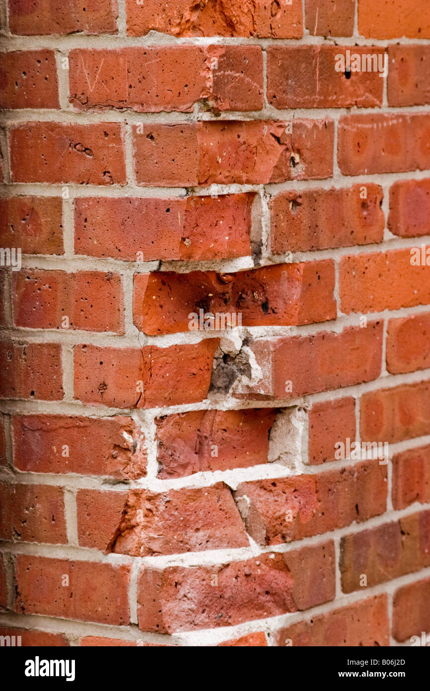 Corner of a brick buliding with some broken bricks Stock Photo - Alamy