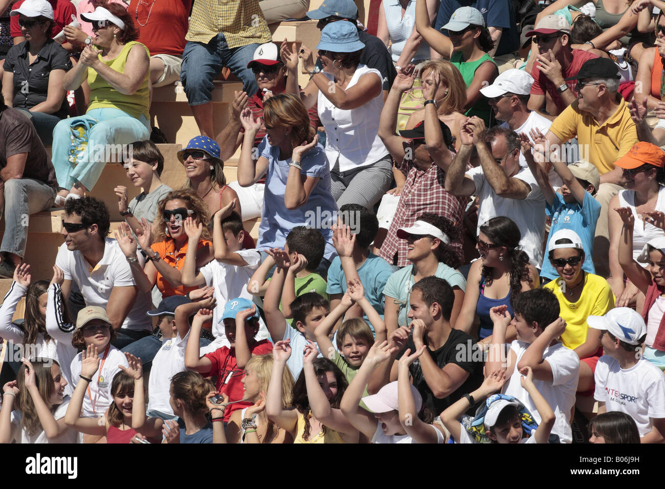 Spectators at a tennis match waving Abama Tenerife Canary islands Spain ...