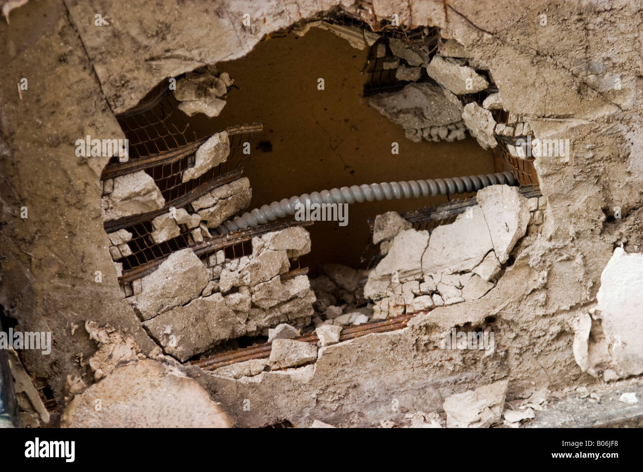 Electrical cable seen through a hole in the wall of a building Stock ...