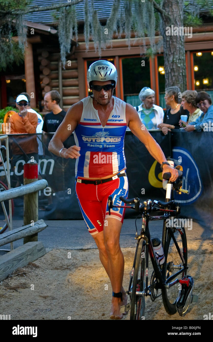 Male Triathlon Athlete Running with his Bicycle at the Disney 70.3 Mile ...