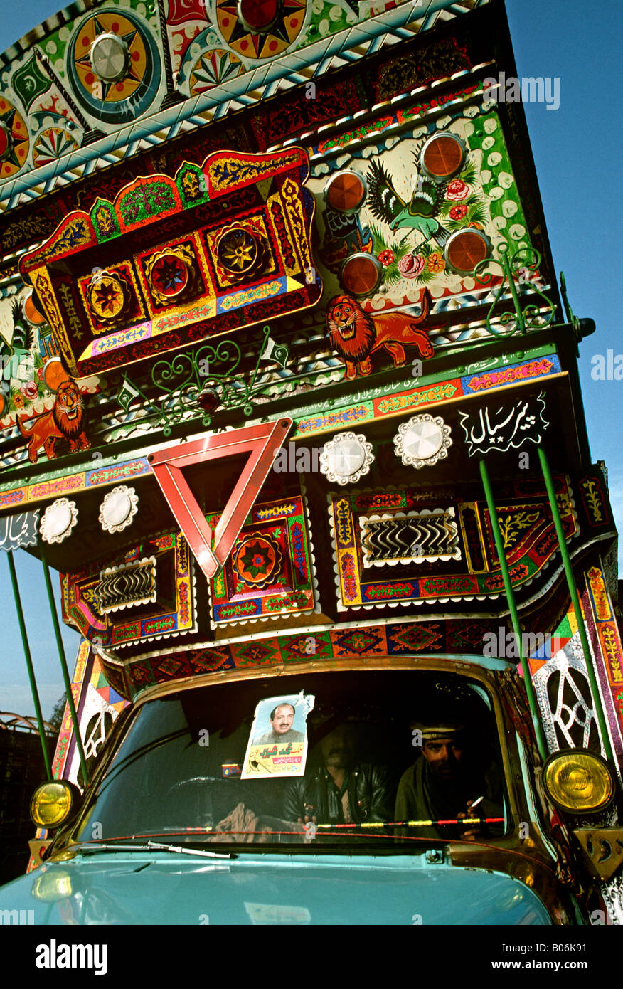 Pakistan Punjab Grand Trunk Road transport men in cab of decorated ...