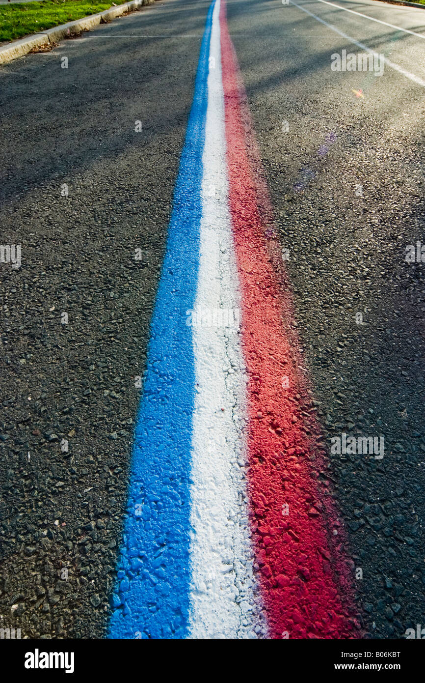 Red white and blue lines drawn down a city street Stock Photo - Alamy