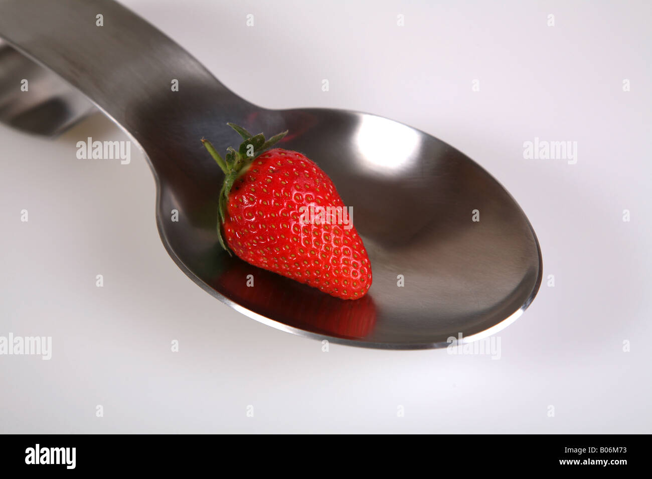 Strawberry in a spoon Stock Photo - Alamy