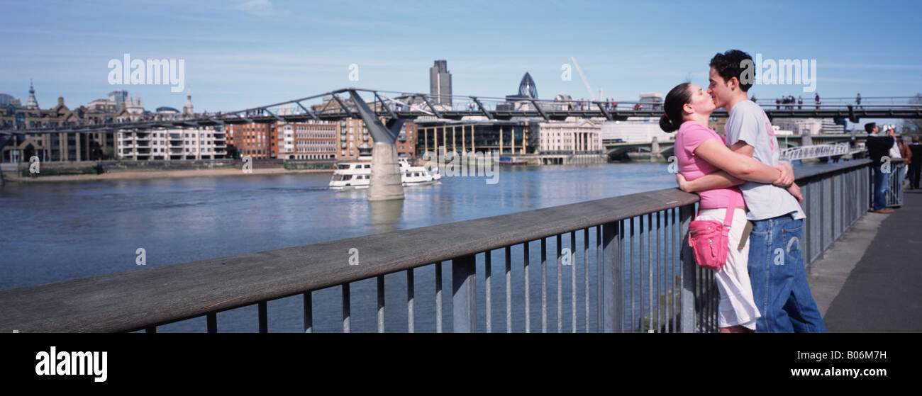 Young couple kissing along the river Thames London England Britain UK ...