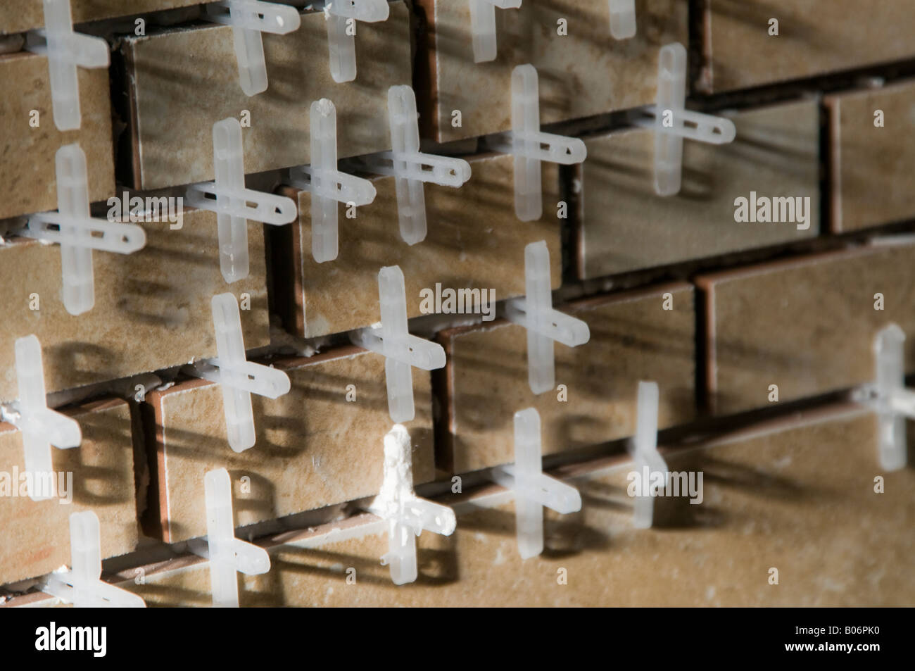 Tiling spacers inbetween mosaic tiles Stock Photo - Alamy