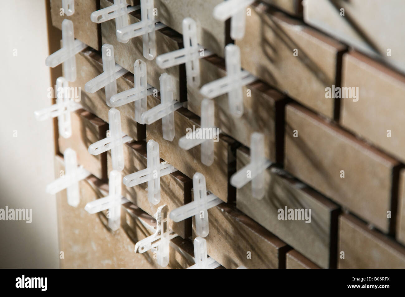 Tiling spacers inbetween mosaic tiles Stock Photo - Alamy