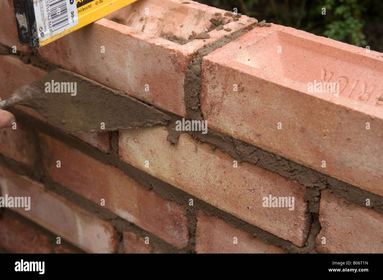 DIY How to build a brick wall Stock Photo - Alamy