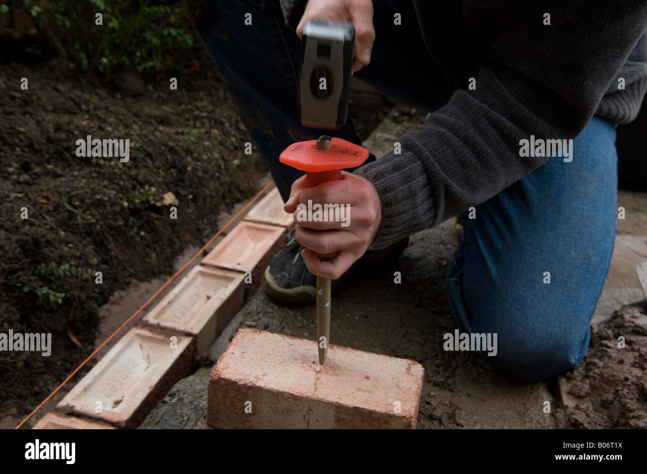 DIY How to build a brick wall Stock Photo - Alamy