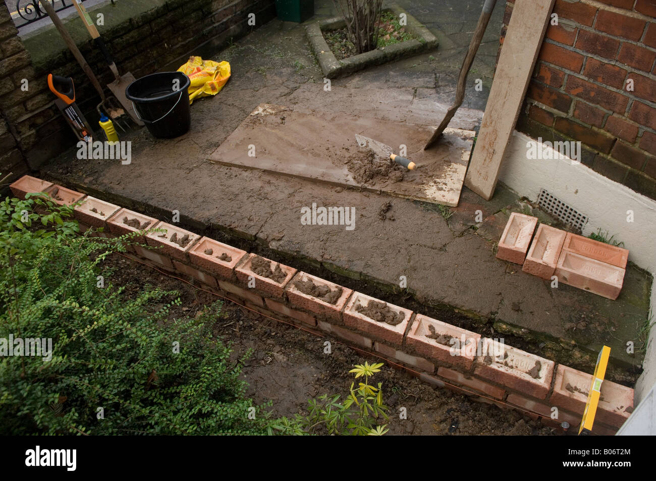 DIY How to build a brick wall Stock Photo - Alamy