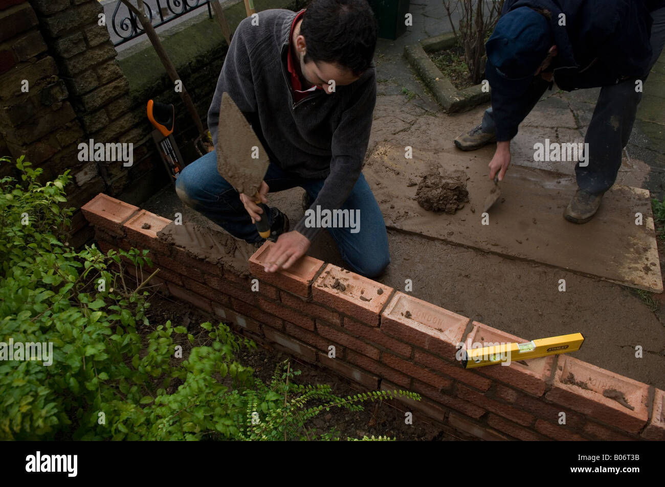DIY How to build a brick wall Stock Photo - Alamy