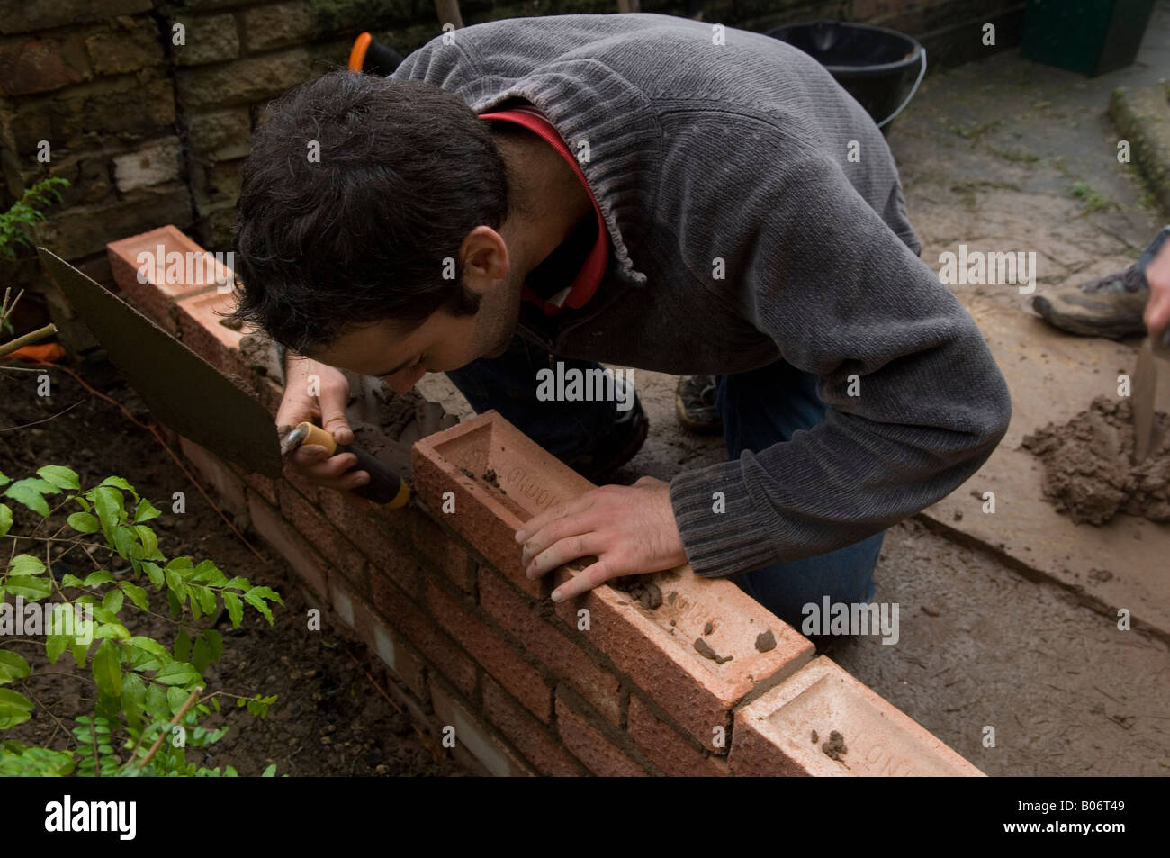 DIY How to build a brick wall Stock Photo - Alamy