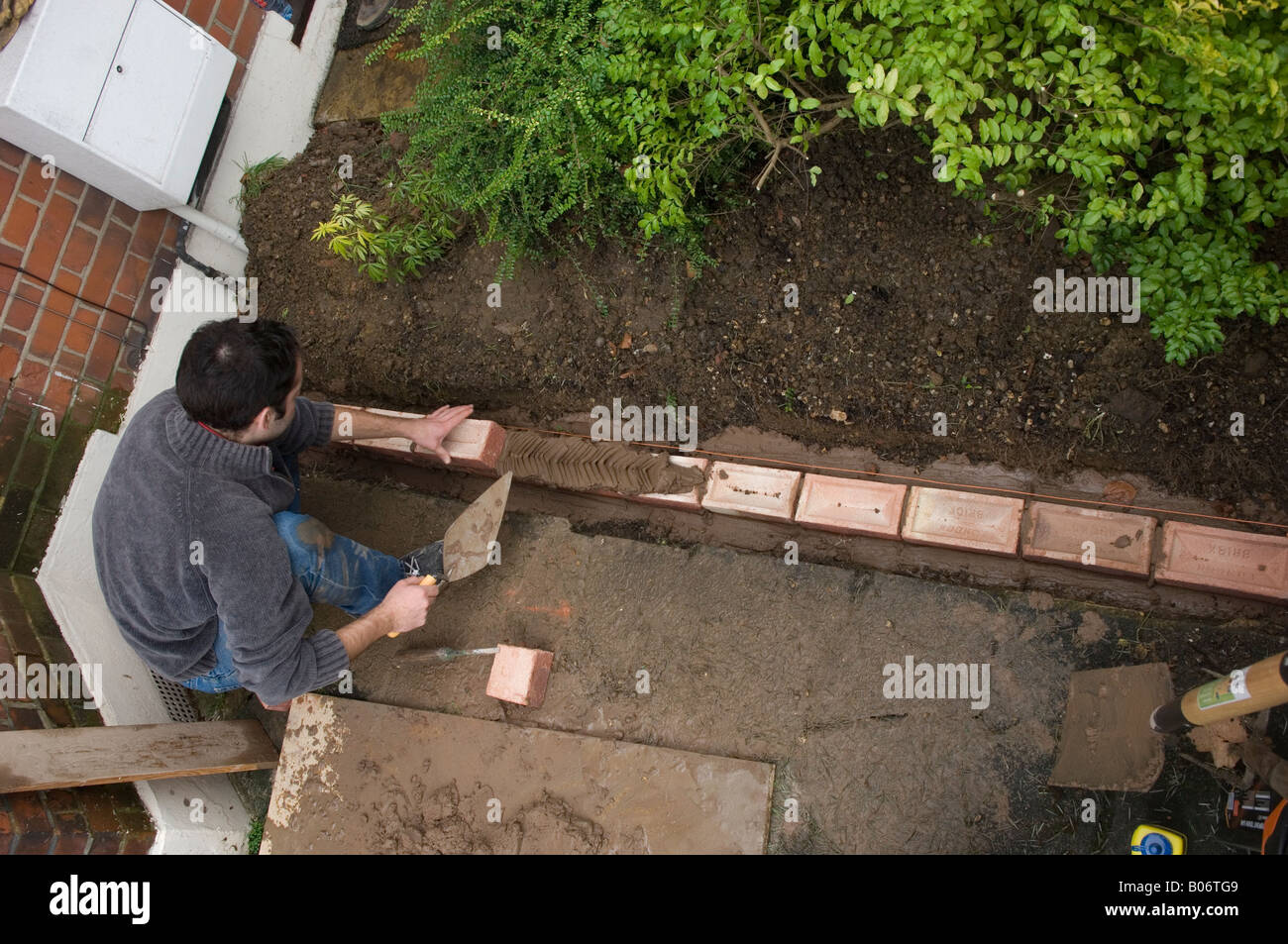 DIY How to build a brick wall Stock Photo - Alamy