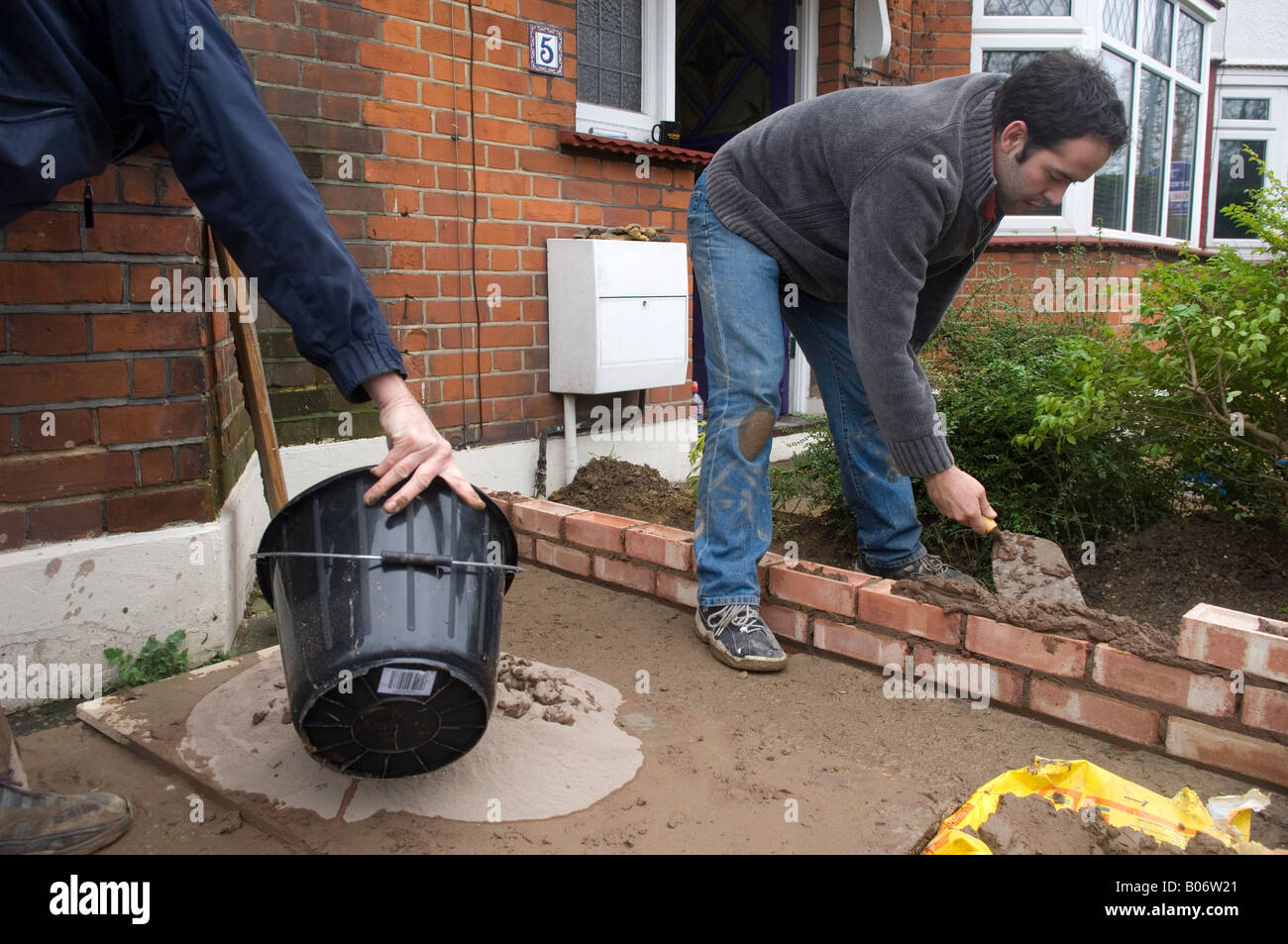 DIY How to build a brick wall Stock Photo - Alamy