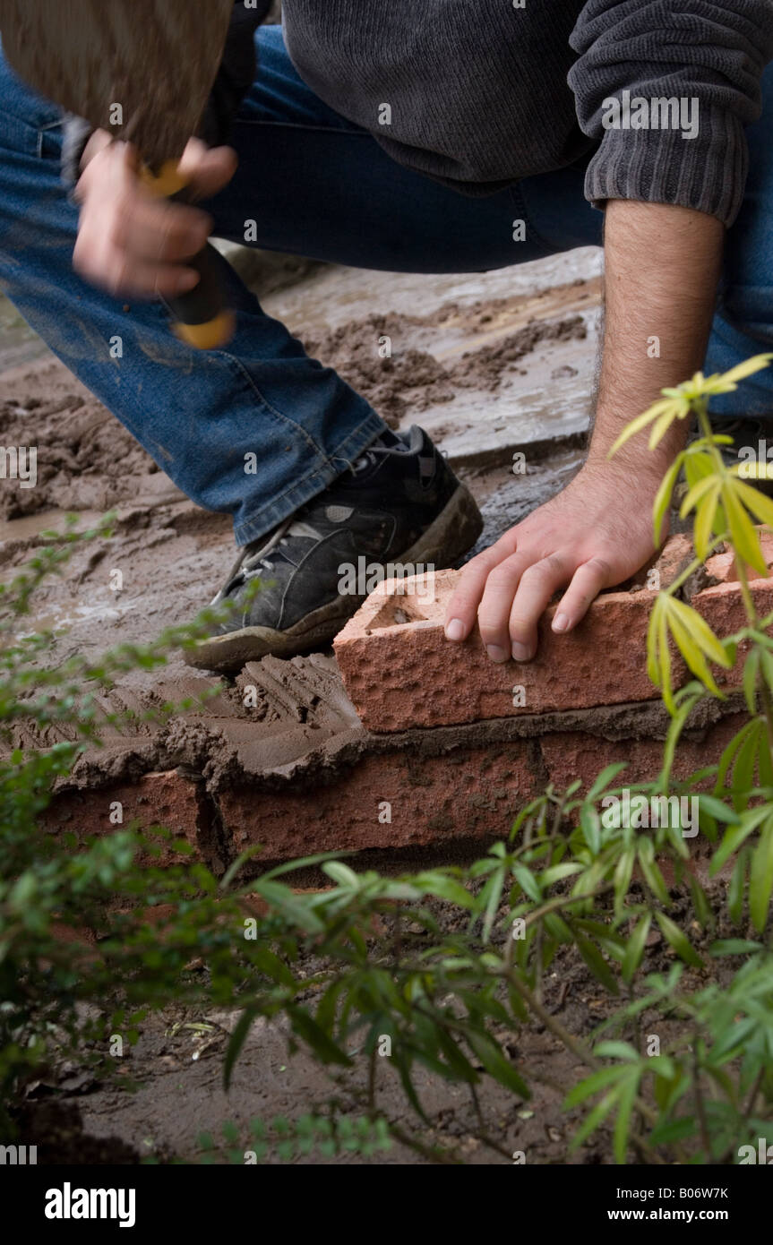 DIY How to build a brick wall Stock Photo - Alamy