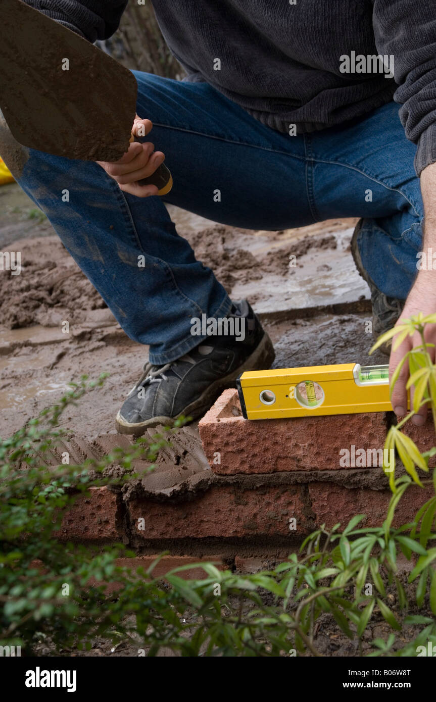 DIY How to build a brick wall Stock Photo - Alamy